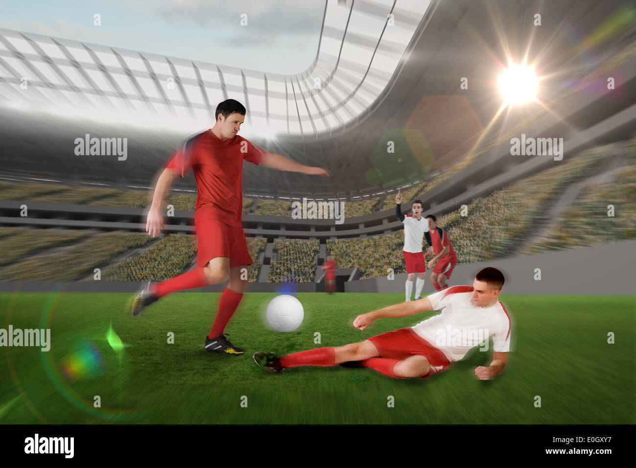 Football player in red kicking Stock Photo - Alamy