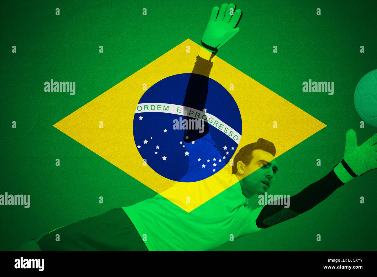 Goalkeeper in yellow making a save against brazil flag in grunge effect ...