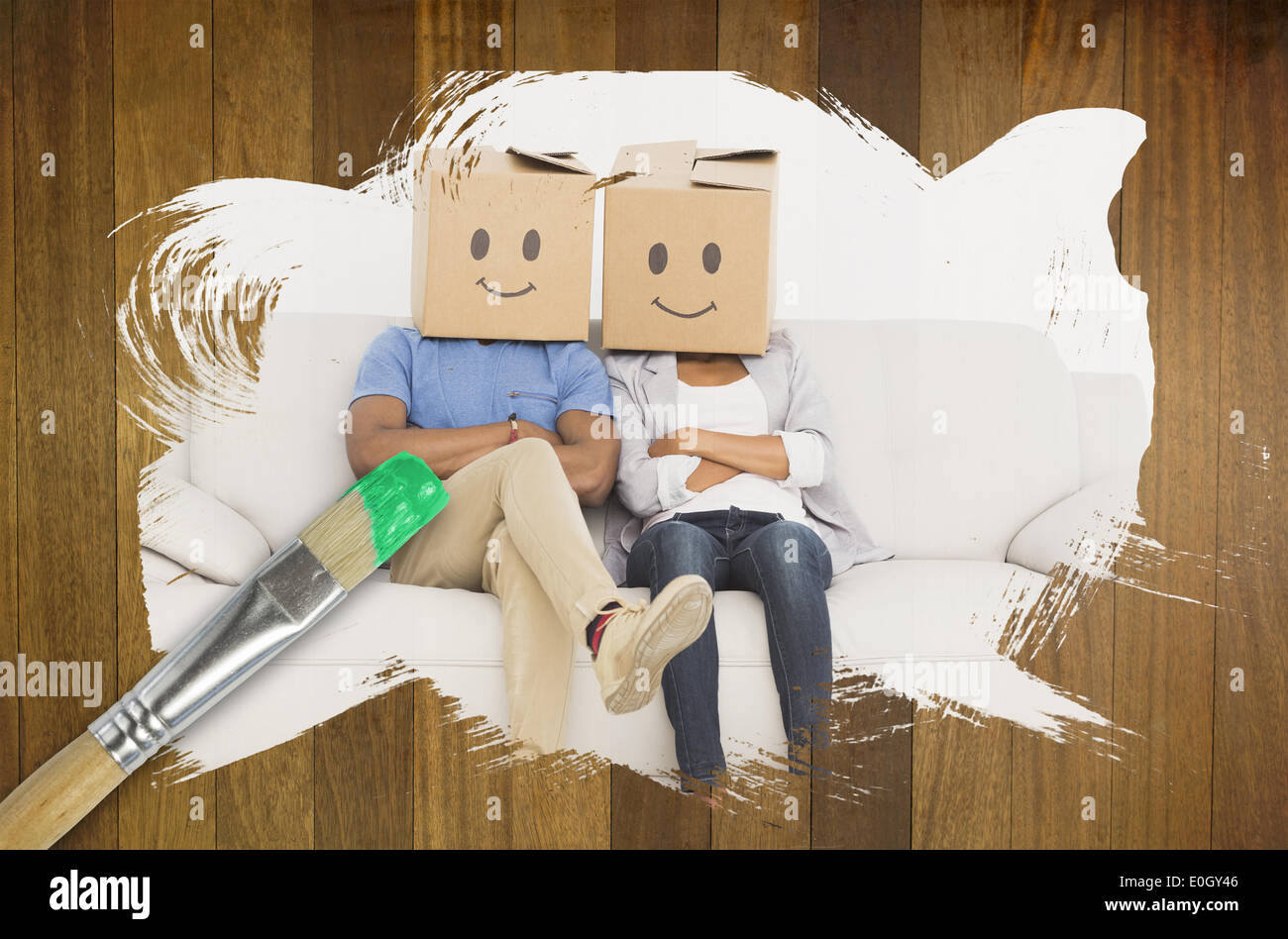 Composite image of couple wearing boxes on head Stock Photo - Alamy