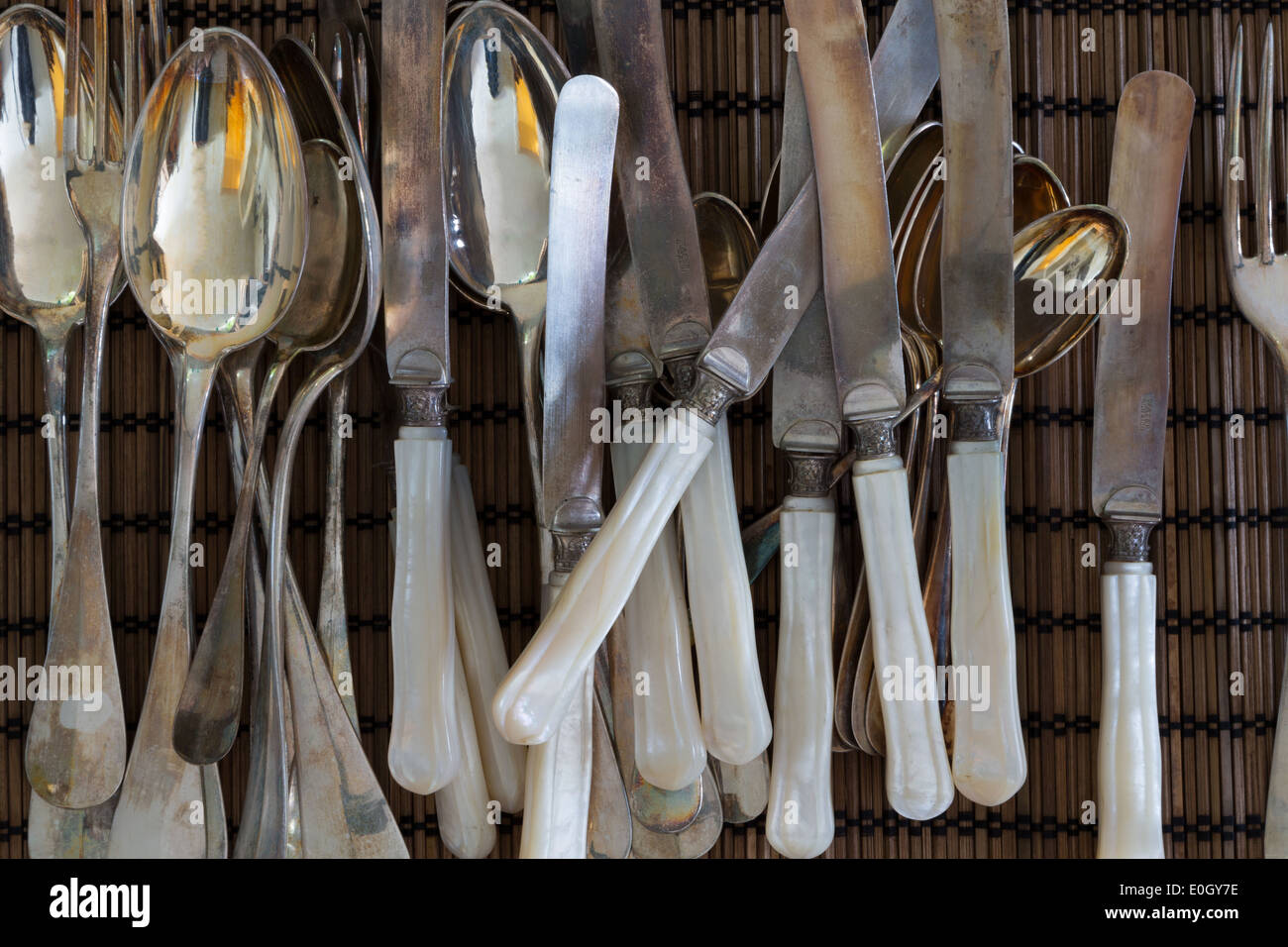 A photograph of some well used antique silver cutlery Stock Photo - Alamy