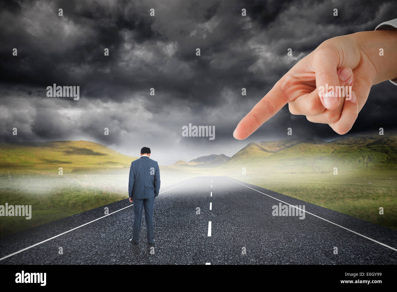 Giant hand pointing at businessman standing Stock Photo - Alamy
