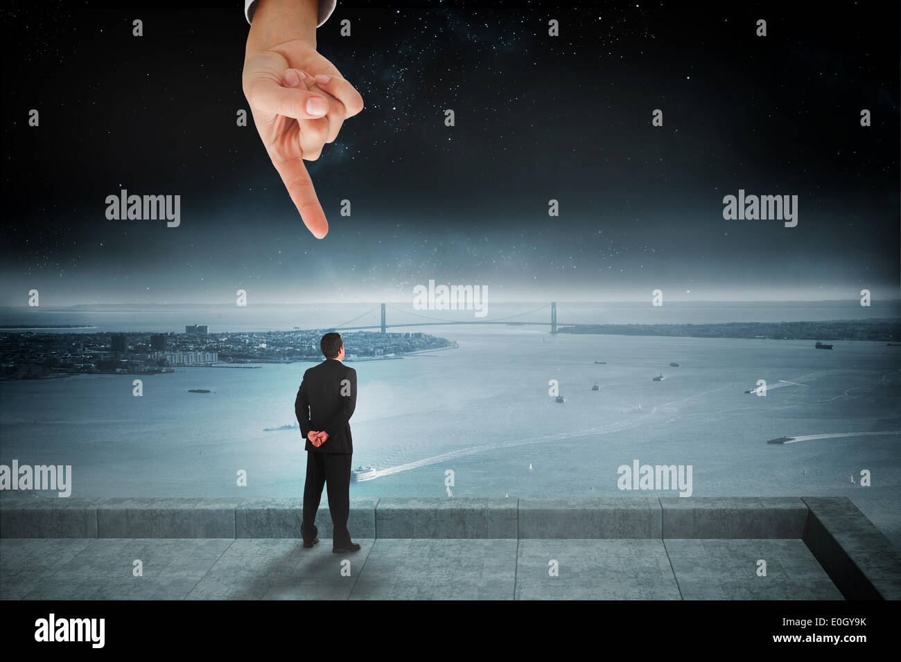 Giant hand pointing at businessman standing and looking Stock Photo - Alamy