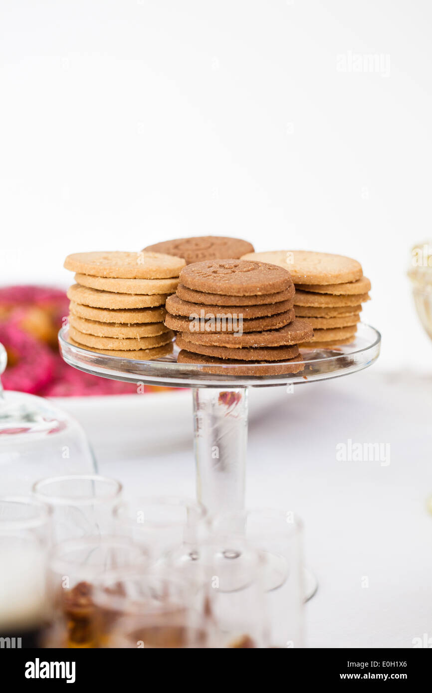 Closeup of four stacks of dry biscuits on glass serving stand Stock ...