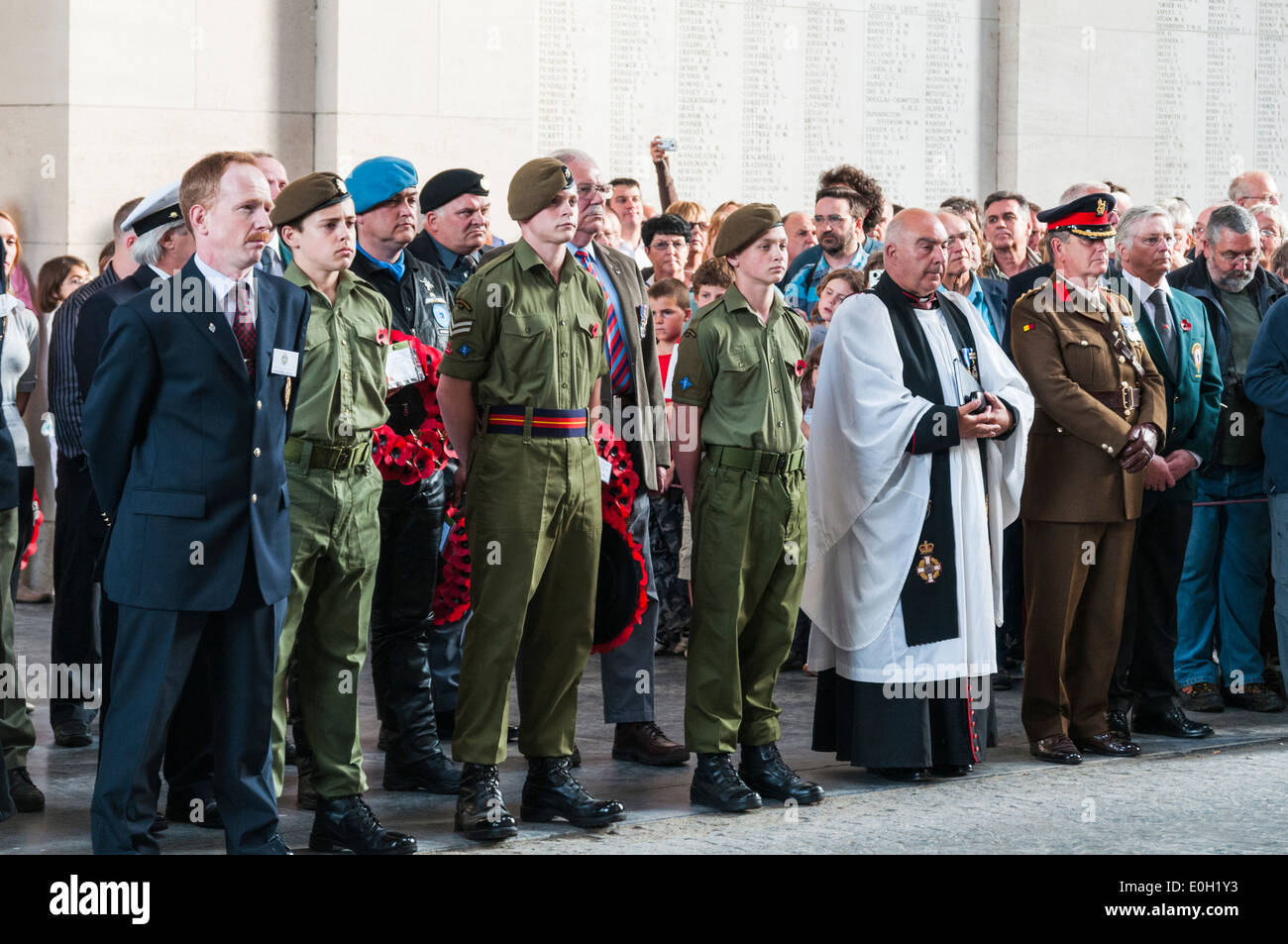 British Army Cadets standing with a priest paying their respects at a ...