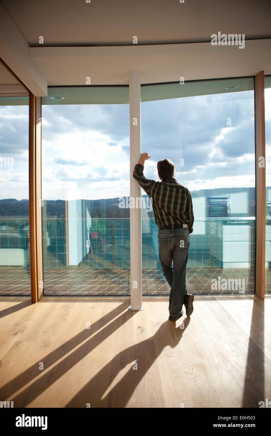 Man looking in the sky through the window passive house, Styria ...