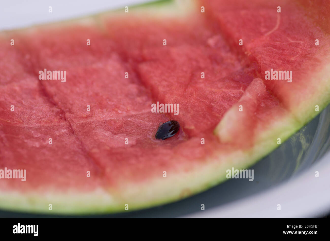 watermelon slice with seed on a plate close up Stock Photo - Alamy