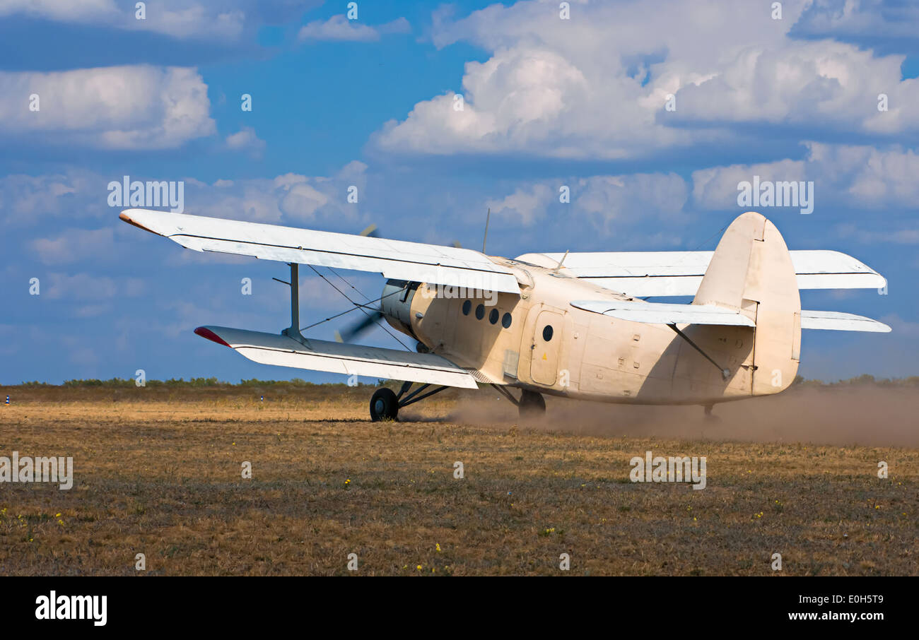 Old airplane takes off on the field Stock Photo - Alamy