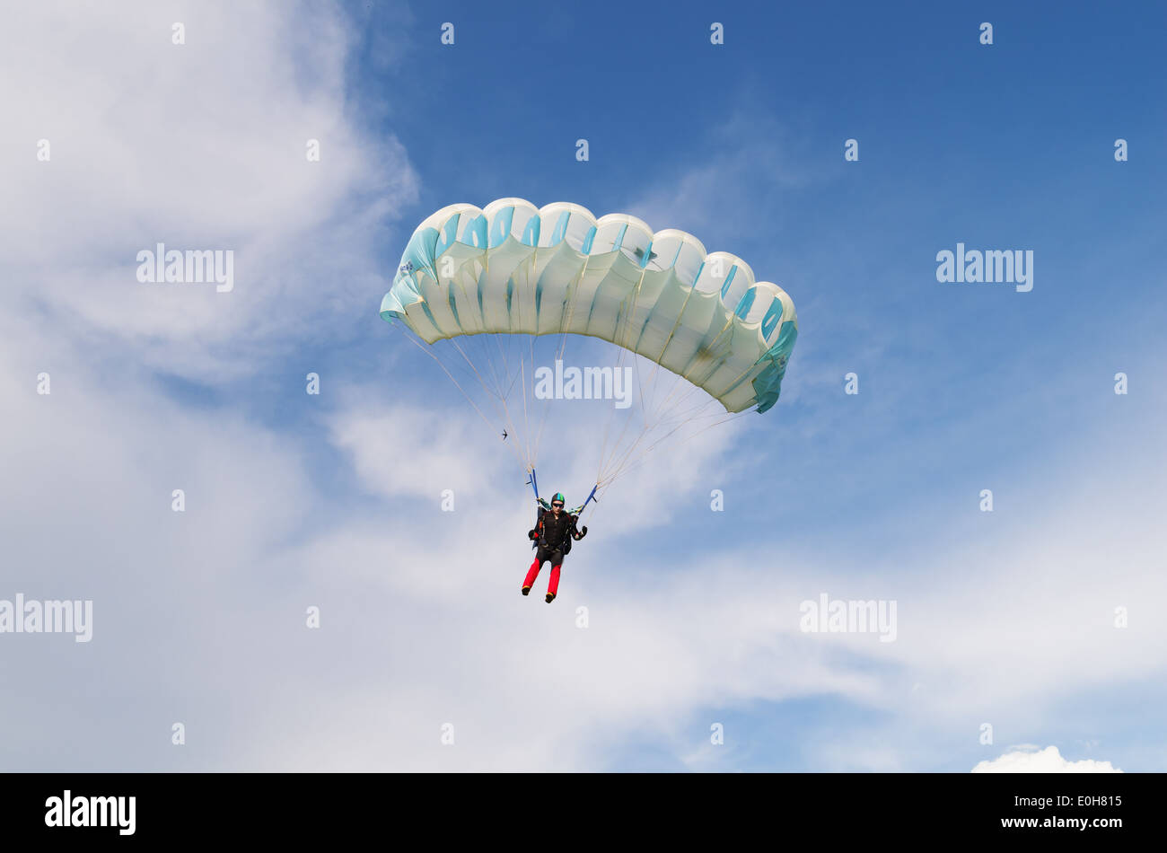 One day with parachutist in airfield. The skydiver landing under white ...