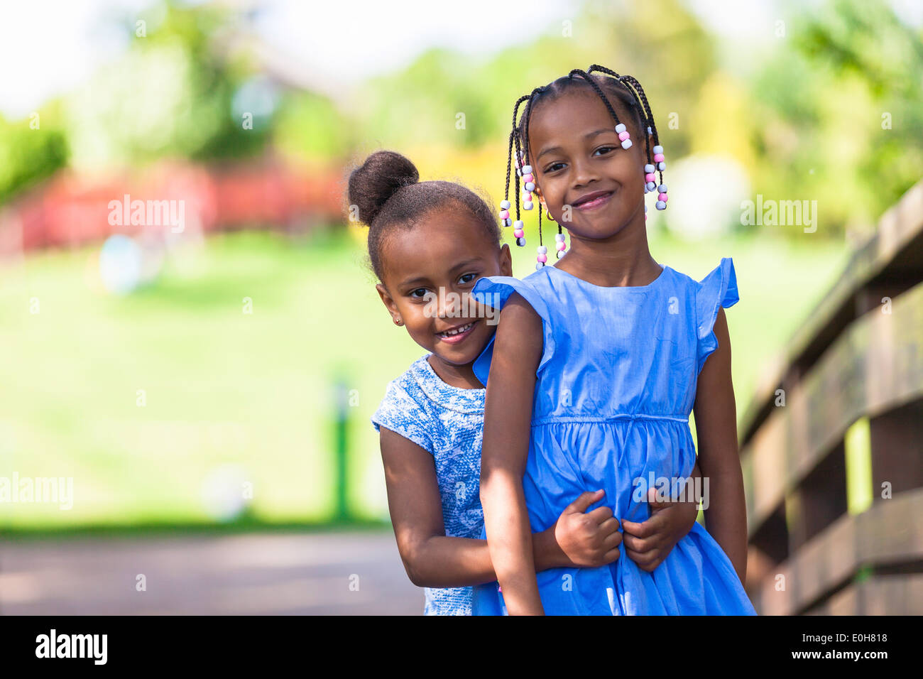 Outdoor portrait of a cute young black sisters smiling - African people ...