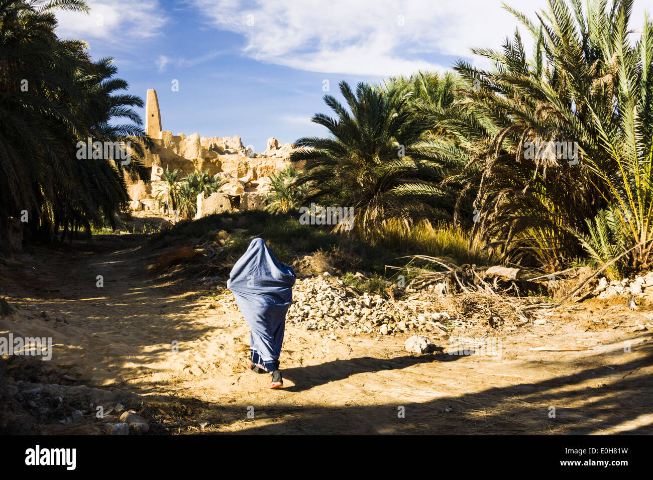 Veiled Siwan woman next to the Temple of the Oracle, Siwa oasis, Egypt ...