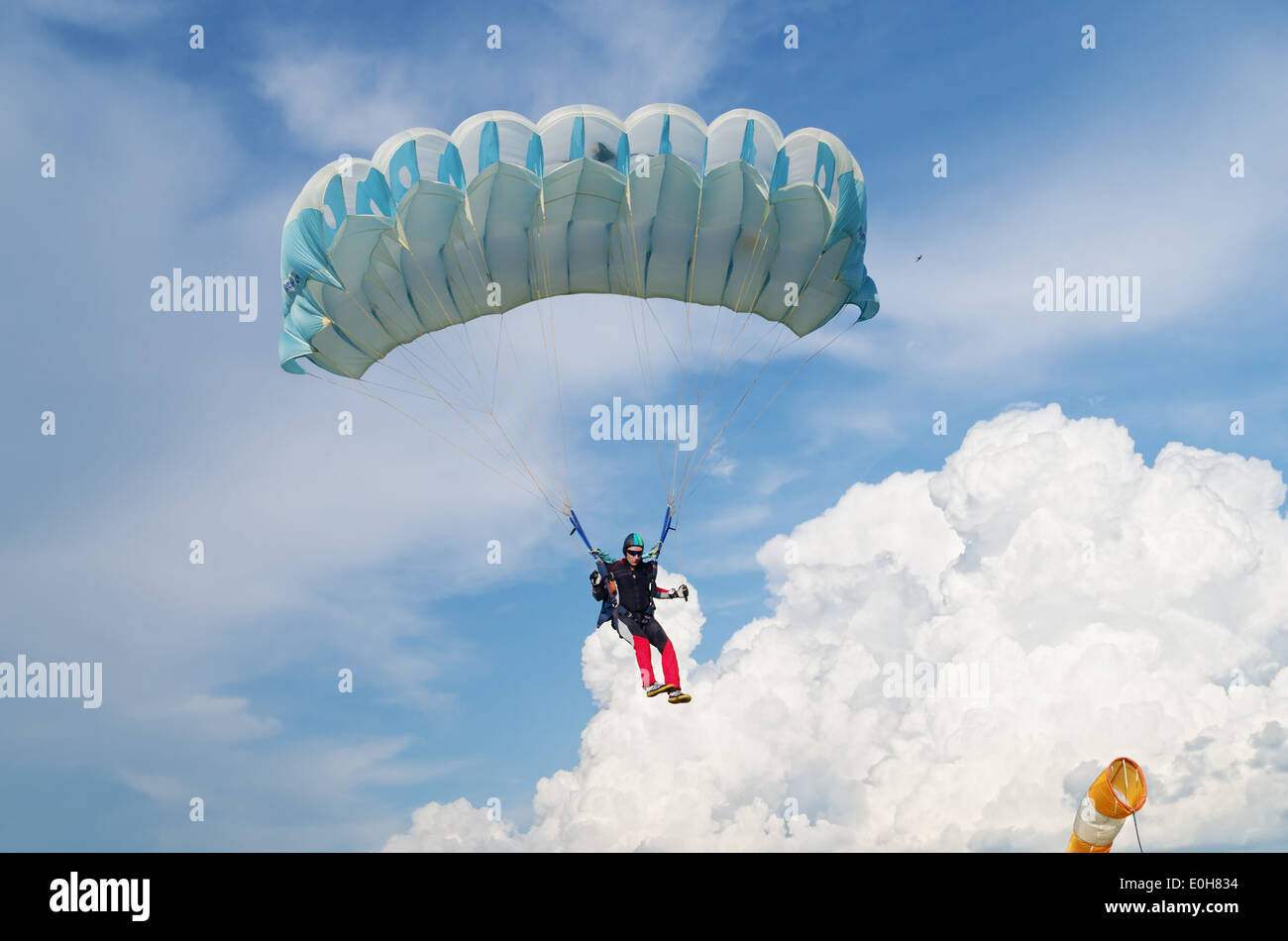 One day with parachutist in airfield. The skydiver landing under white ...