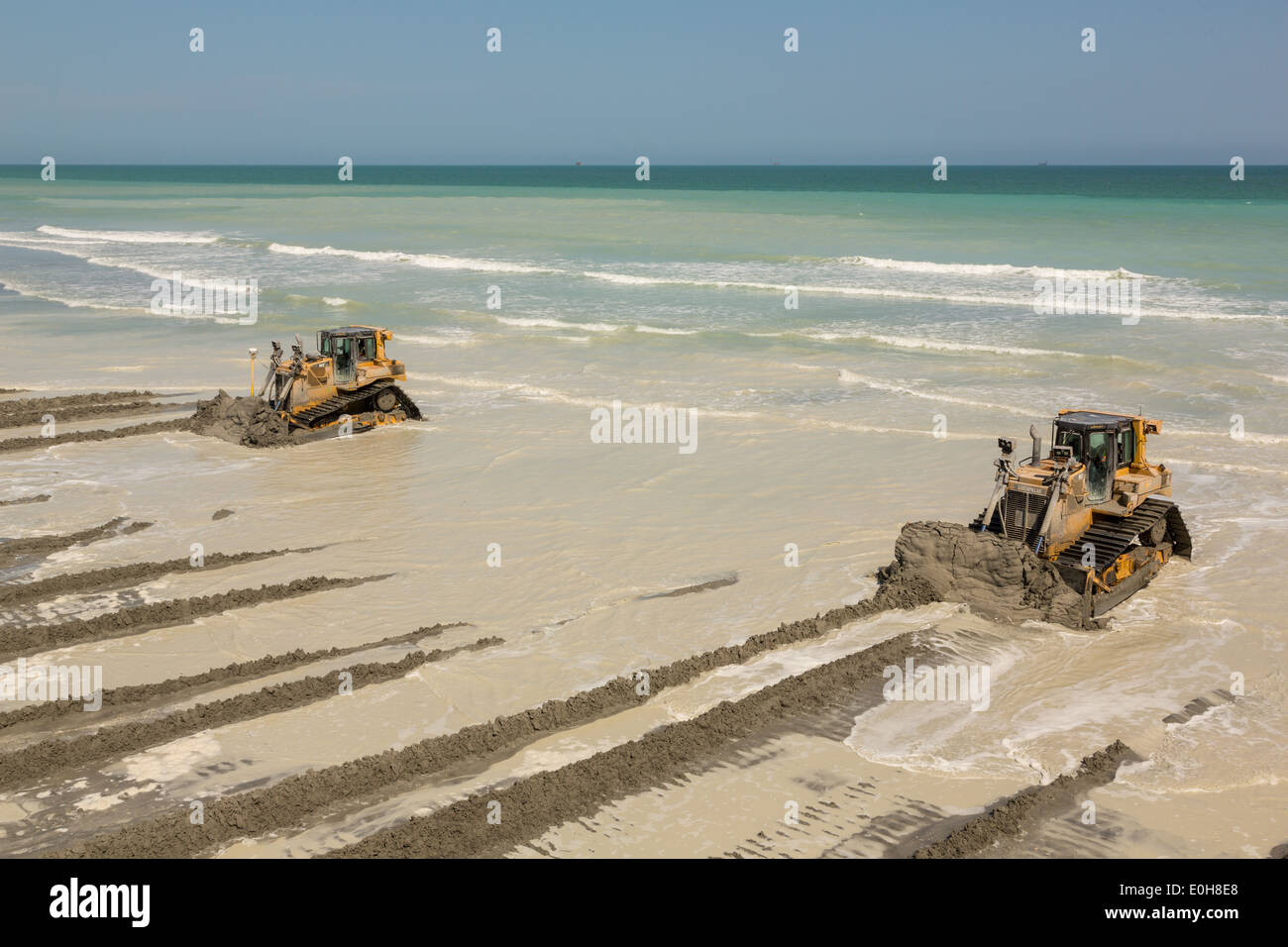 The Army Corps of Engineers use heavy machinery to restore the beach during a major beach ...