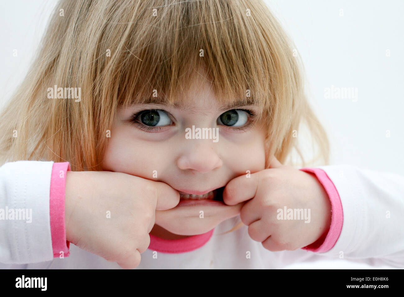FOUR YEAR OLD GIRL PULLING FACES Stock Photo - Alamy
