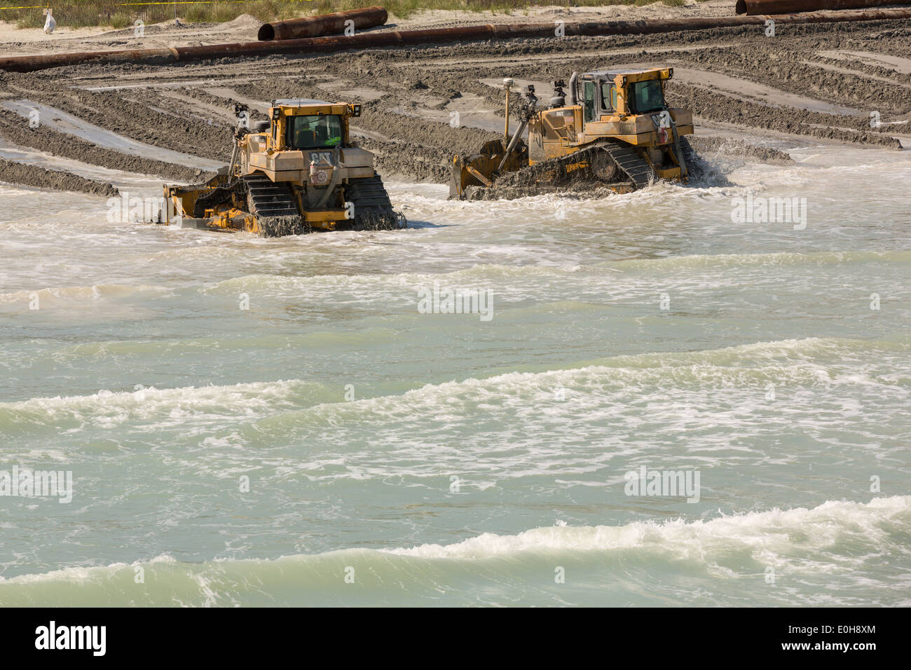 The Army Corps of Engineers use heavy machinery to restore the beach during a major beach ...