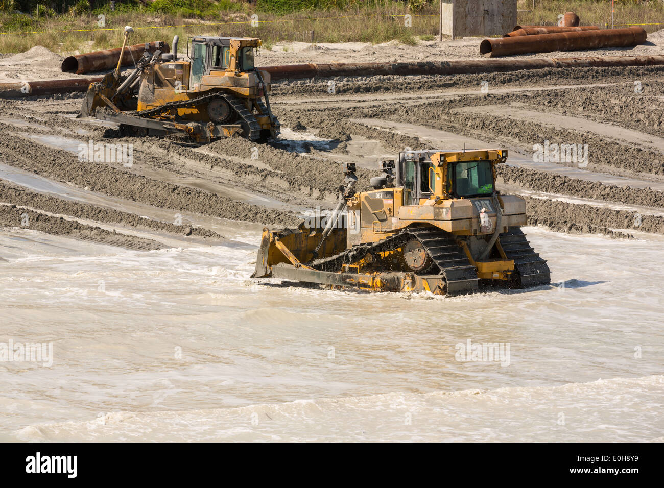 The Army Corps of Engineers use heavy machinery to restore the beach during a major beach ...