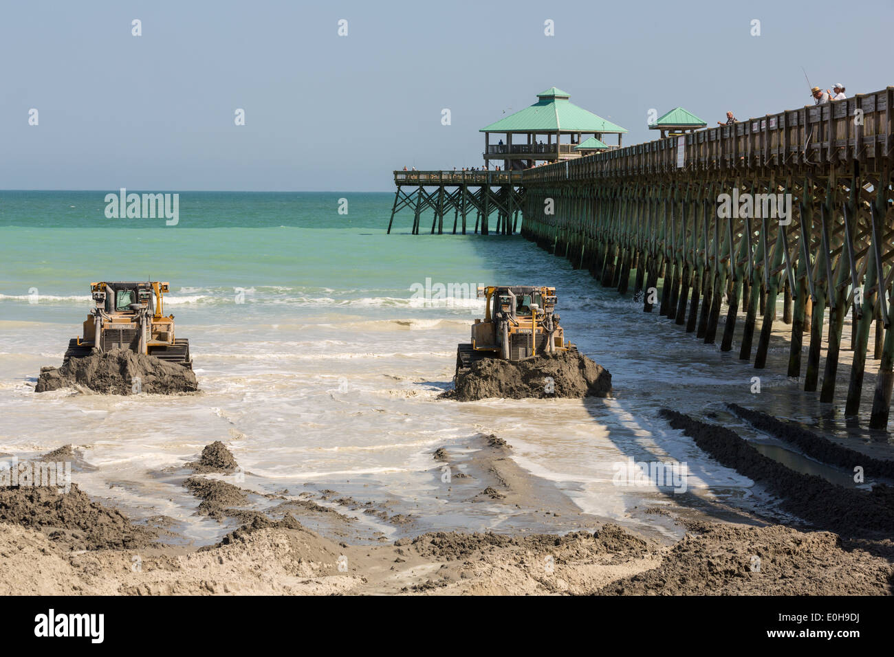 The Army Corps of Engineers use heavy machinery to restore the beach during a major beach ...