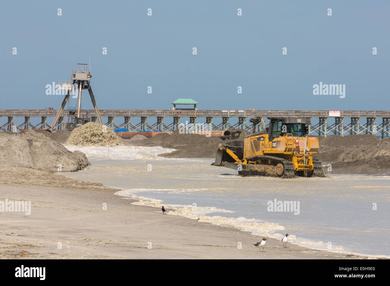 The Army Corps of Engineers use heavy machinery to restore the beach during a major beach ...