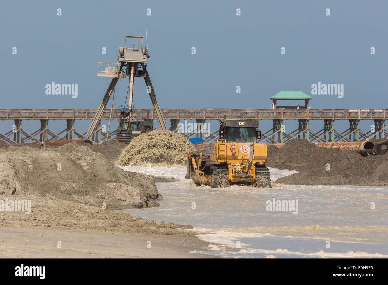 The Army Corps of Engineers use heavy machinery to restore the beach during a major beach ...