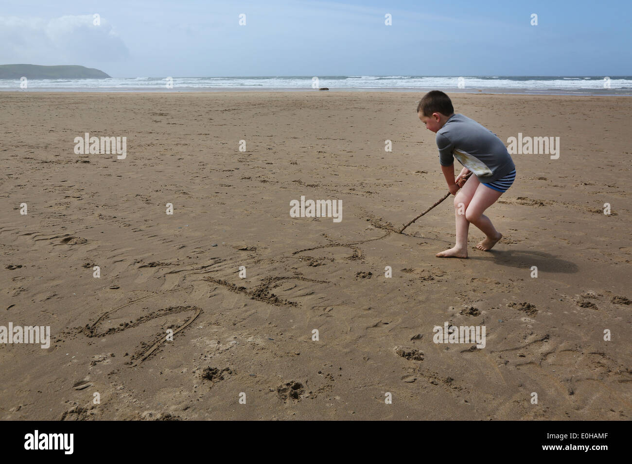 Child writing his name in the sand Stock Photo - Alamy