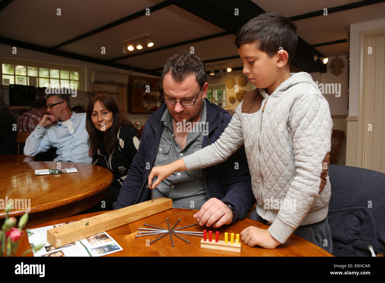 Father and son trying to solve puzzles Stock Photo - Alamy