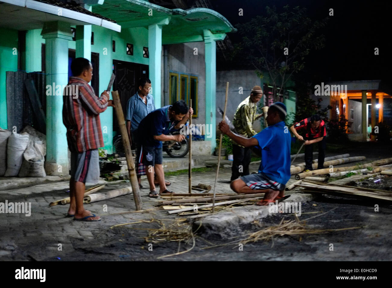 indonesian local villagers working at night by the light of a single ...