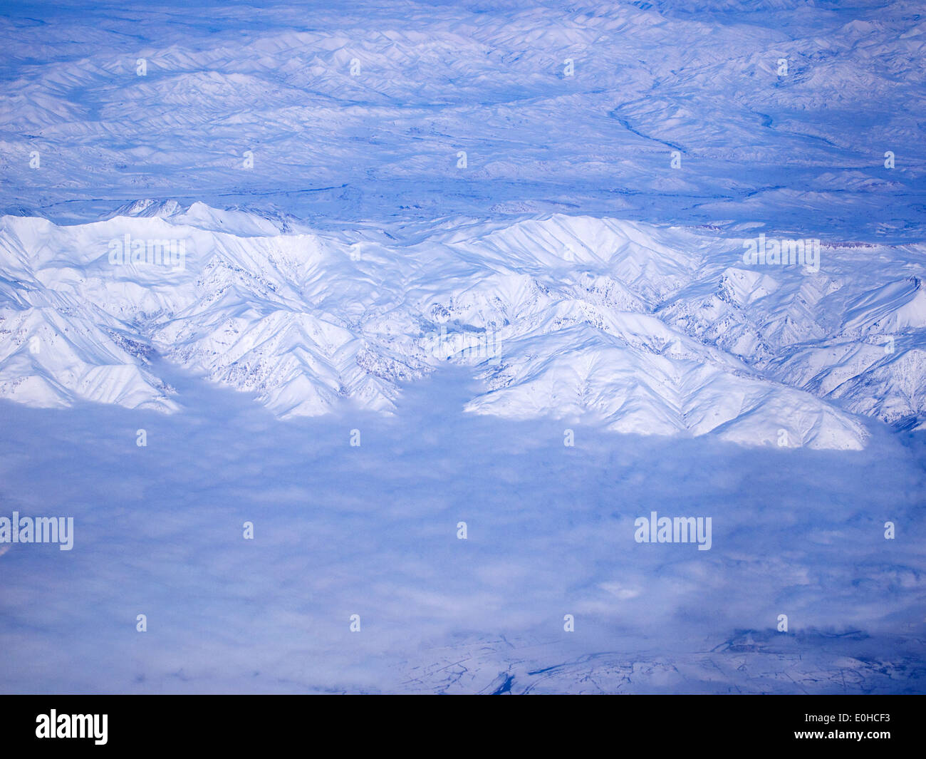 Snowy mountains from above with white clouds Stock Photo - Alamy