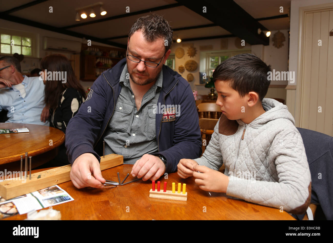 Father and son trying to solve puzzles Stock Photo - Alamy