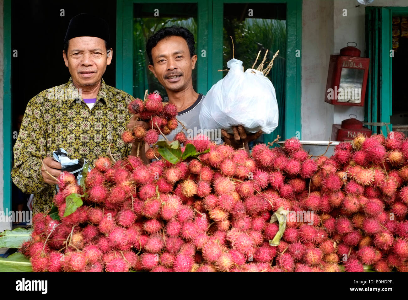 local men selling fresh rambutan fruit from a roadside stall near ...