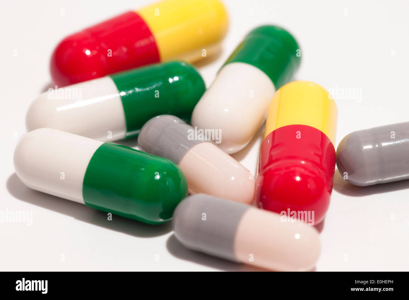 Some capsules and pills isolated on white background Stock Photo - Alamy