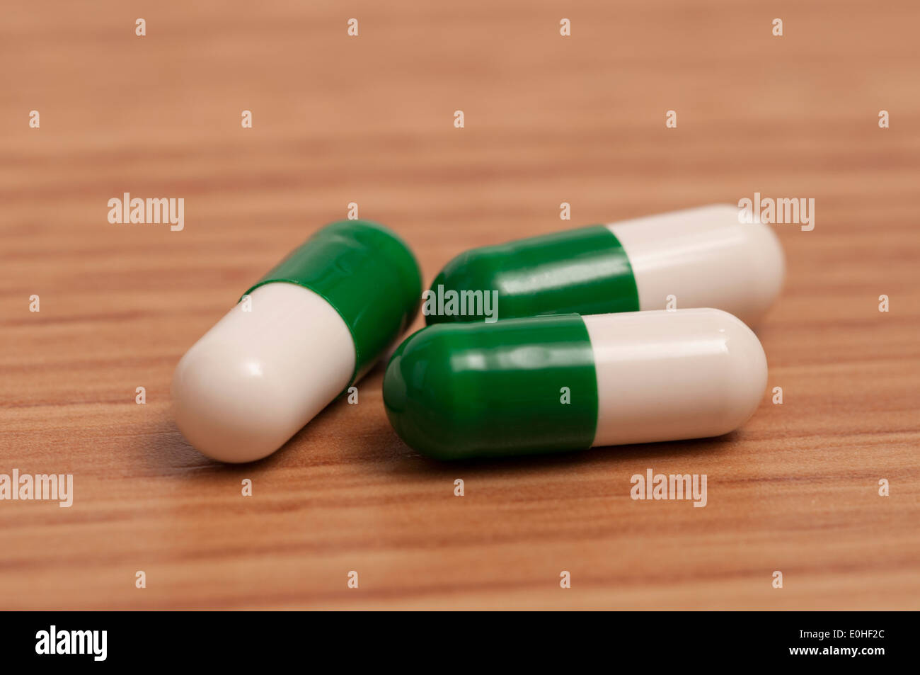 Three capsules or pills on the table Stock Photo - Alamy