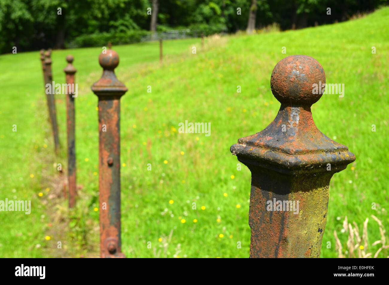 Rusting fence posts in the park waiting to be restored Stock Photo - Alamy