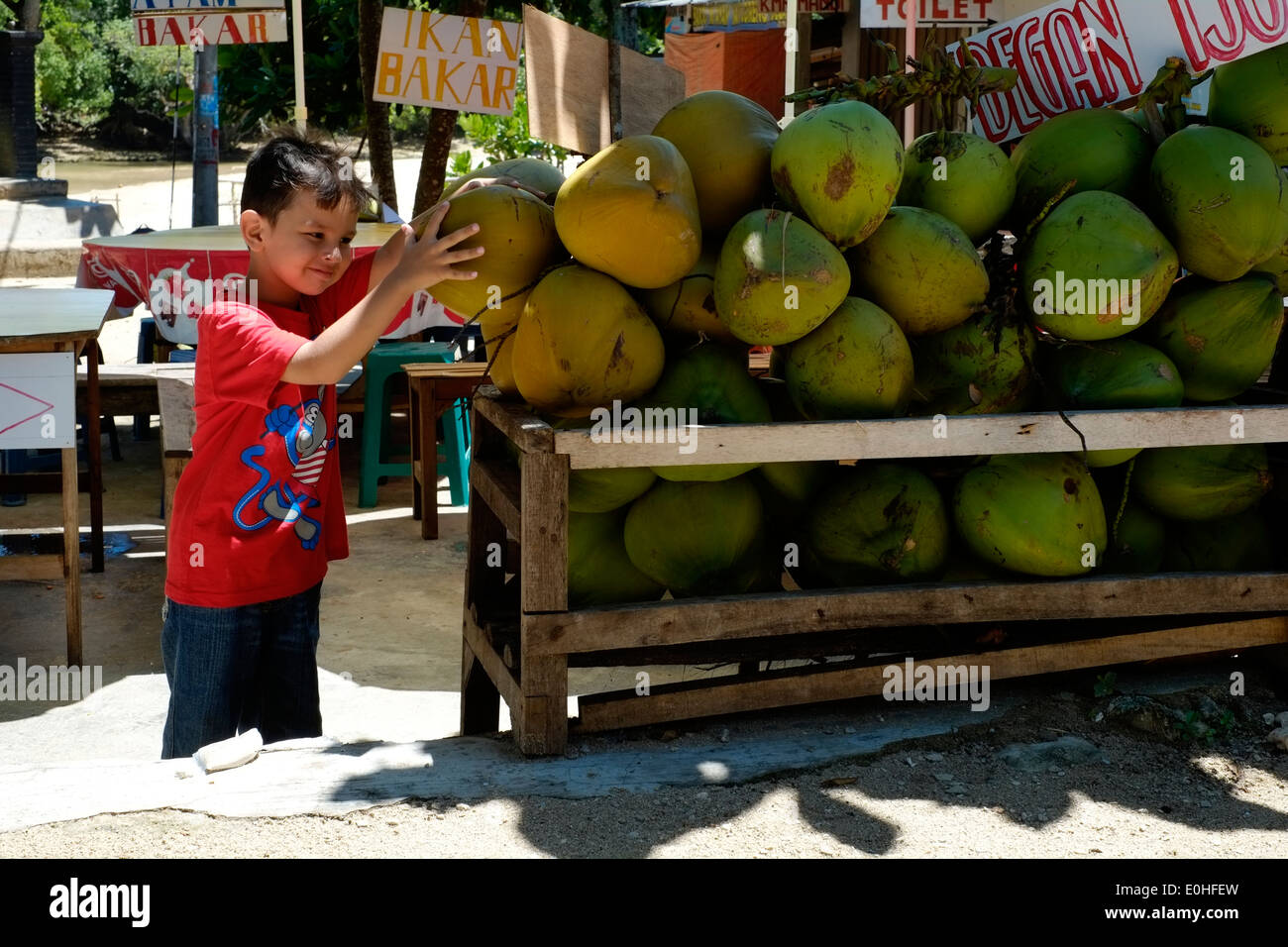 Boy with coconuts hi-res stock photography and images - Alamy