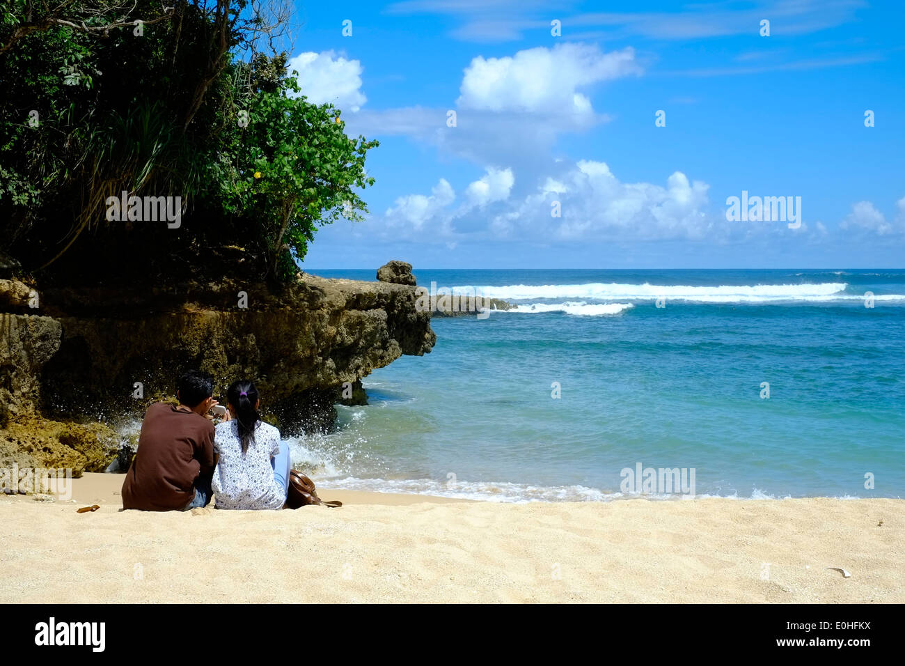 young local couple enjoying the beach and sea at balekambang east java ...