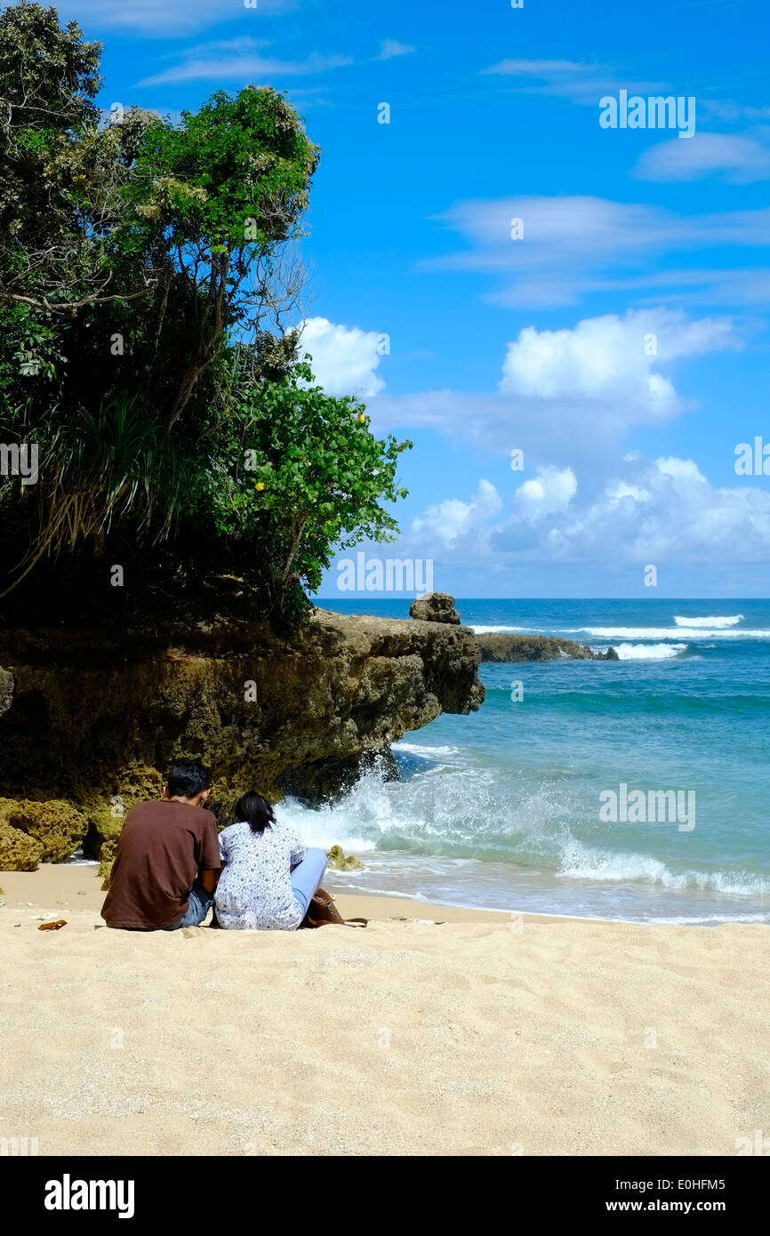 young local couple enjoying the beach and sea at balekambang east java ...