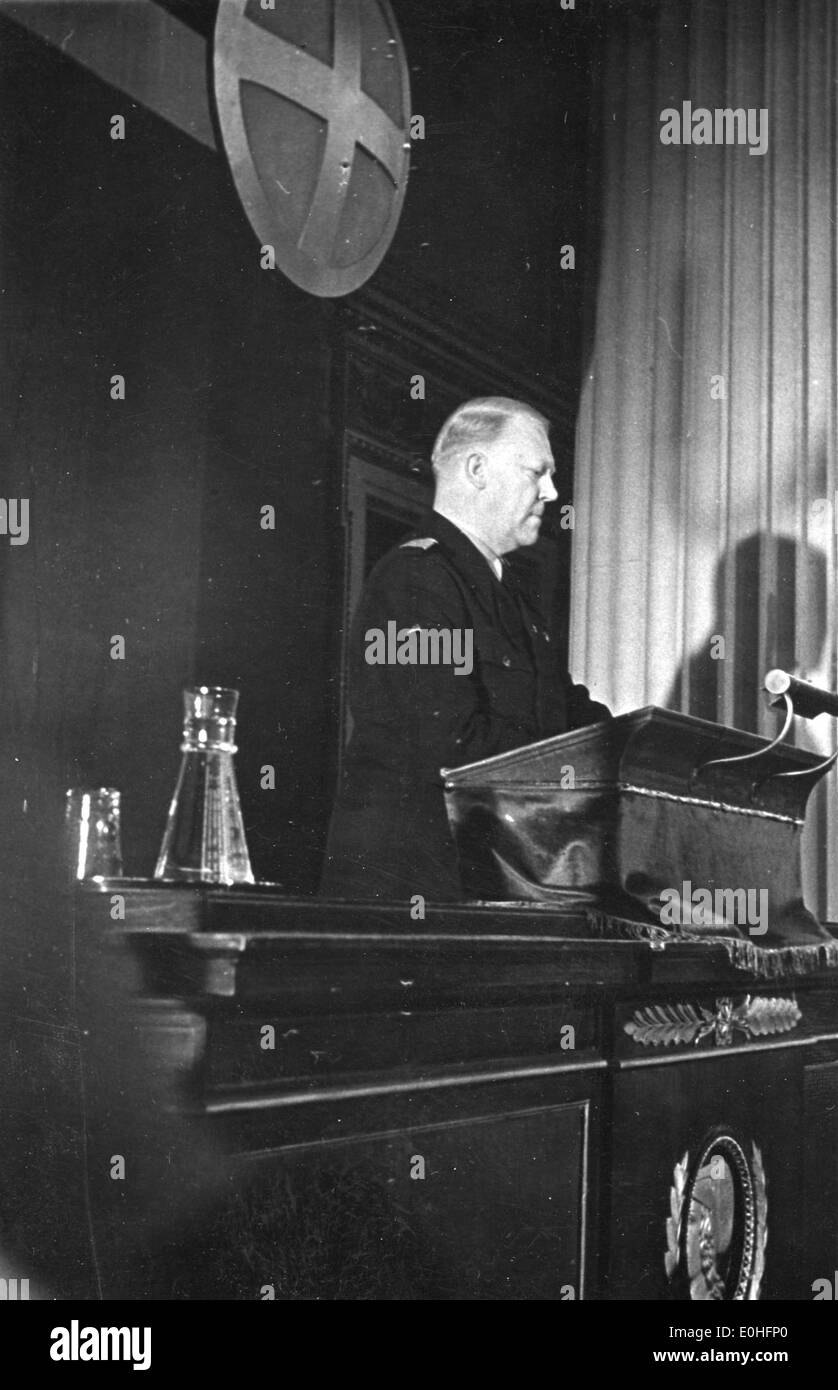 Vidkun Quisling is seen delivering a speech from the podium ...