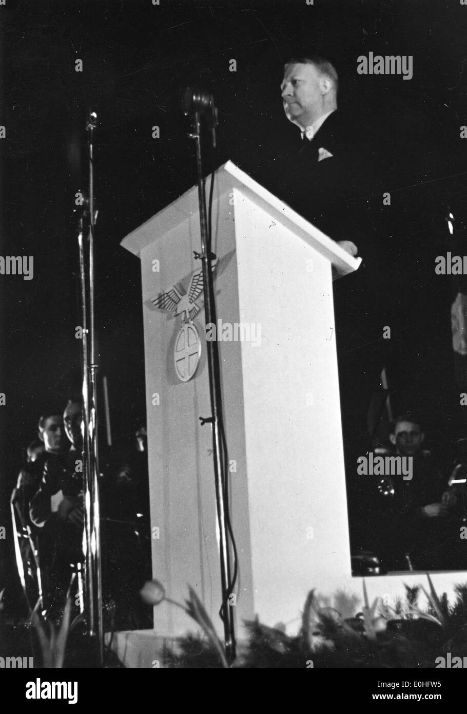 This image shows Vidkun Quisling speaking at a podium during a visit by ...