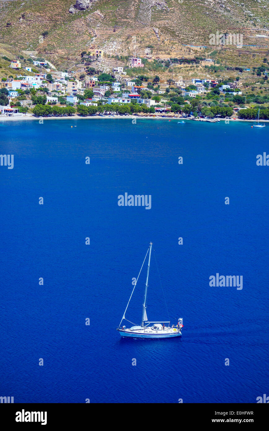 White yacht on blue sea, bay with surrounding hills, Greece Stock Photo ...