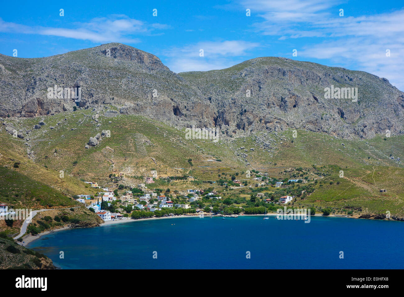 Greek seaside village, blue sea, bay with surrounding hills, Greece ...