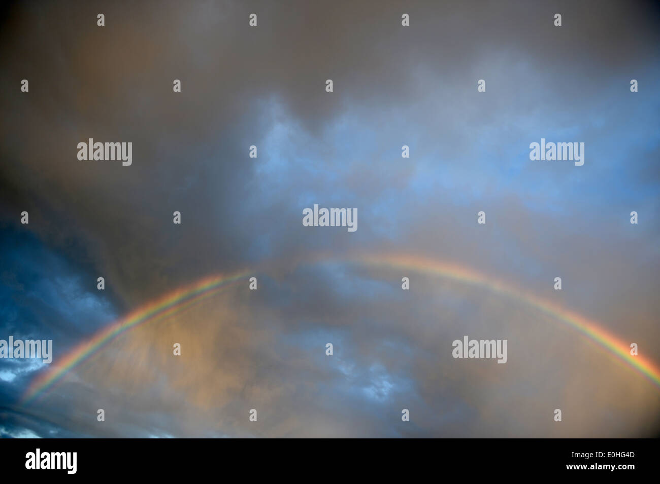 A colorful rainbow in a cloudy sky Stock Photo - Alamy