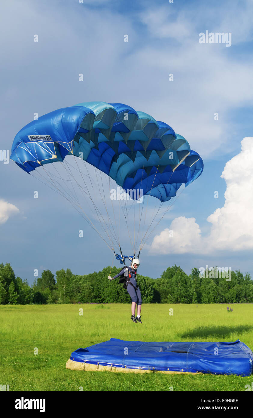 One day with parachutist in airfield. The girl skydiver after landing ...