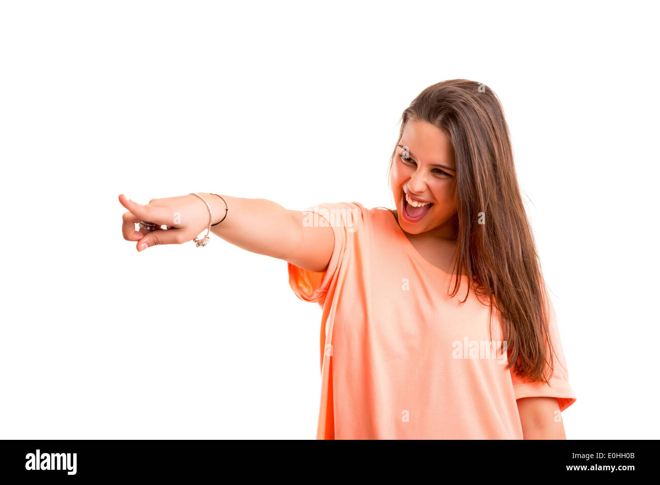 A beautiful woman pointing to something, isolated over a white ...