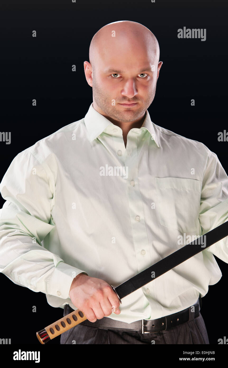 man with a Japanese sword on a black background Stock Photo - Alamy