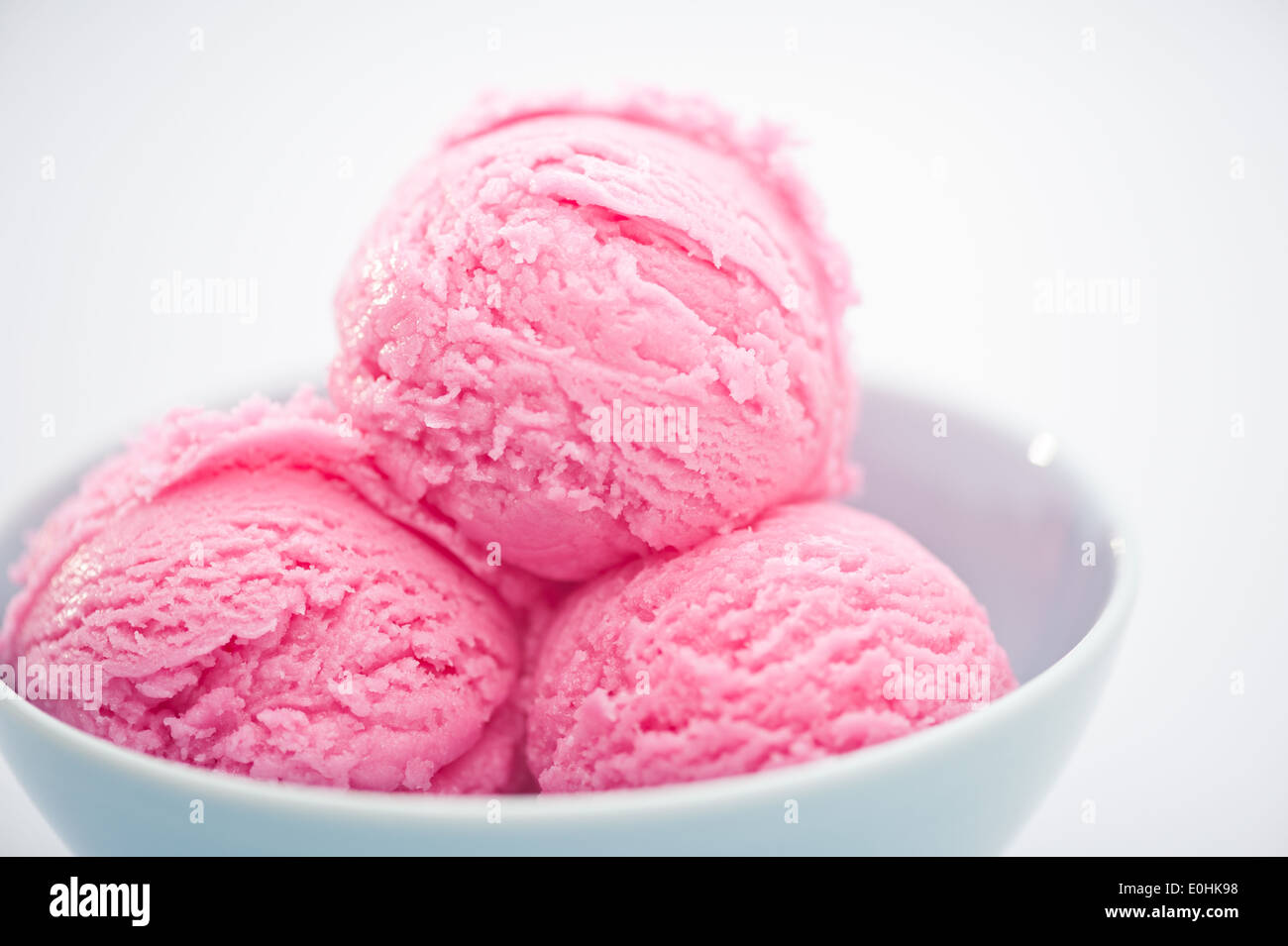 Raspberry ice cream cup over bright background Stock Photo - Alamy
