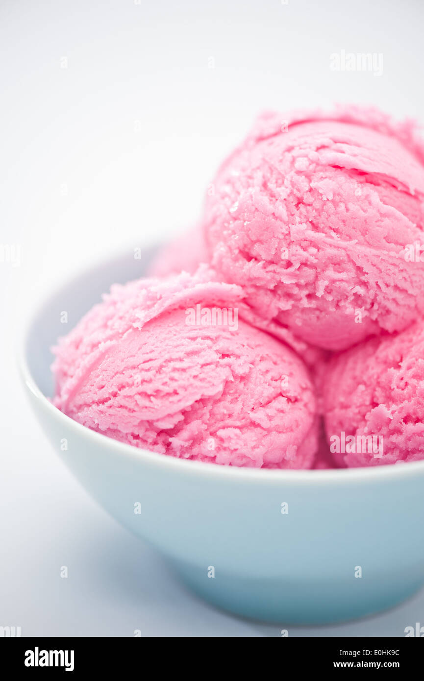 Raspberry ice cream cup over bright background Stock Photo - Alamy