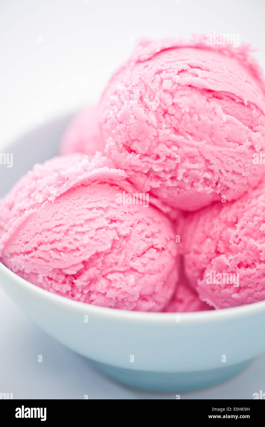Raspberry ice cream cup over bright background Stock Photo - Alamy