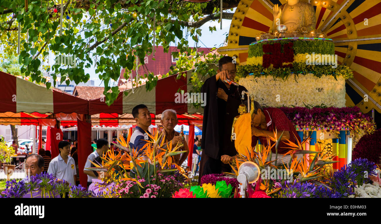 Buddhist priest performing ritual on Buddha statue on a Vesak day that ...