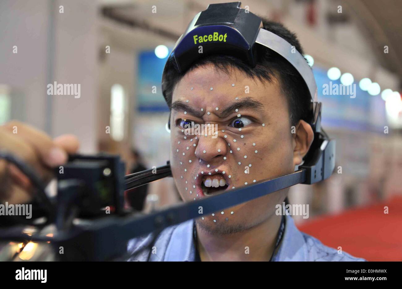 Beijing, China. 14th May, 2014. An exhibitor displays a 3D face-capture ...
