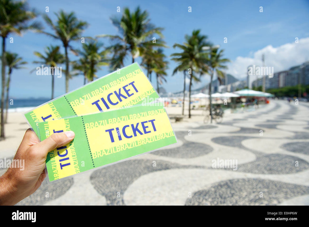 Hands holding pair of tickets to football soccer event in Copacabana ...