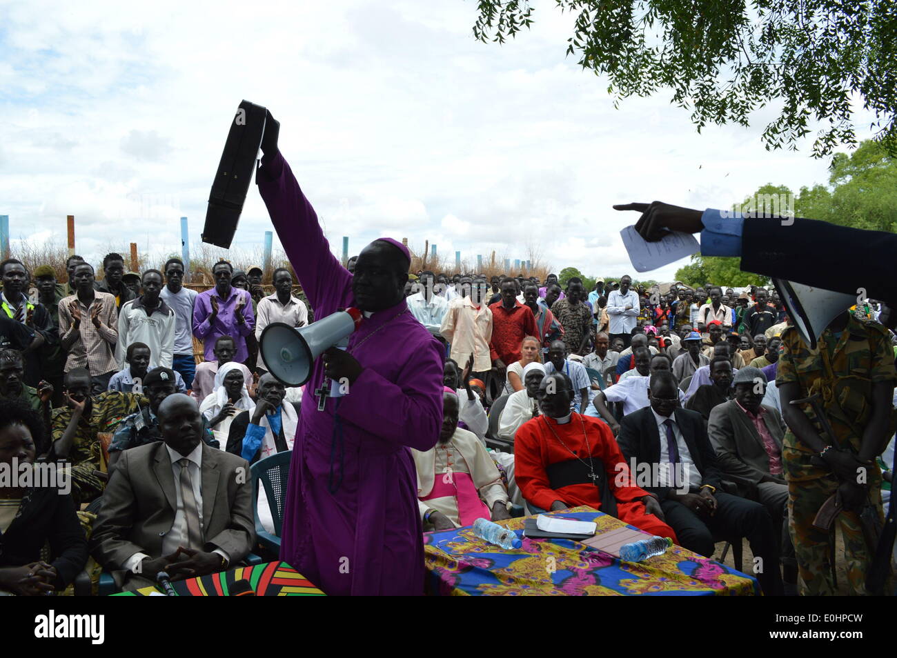 Gumuruk, Jonglei, South Sudan. 13th May, 2014. Priest holds up signed ...