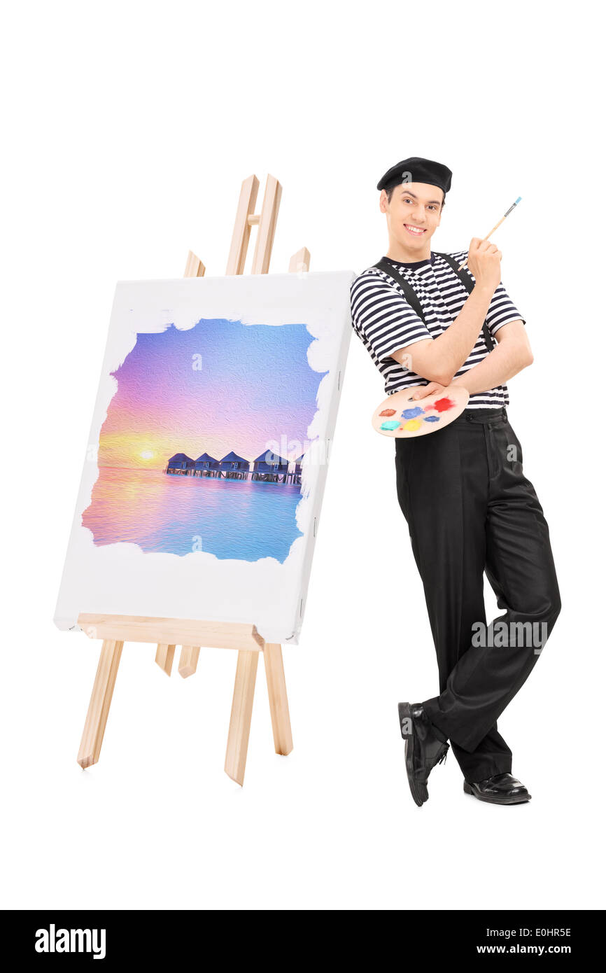 Male artist standing by a painting on an easel Stock Photo - Alamy